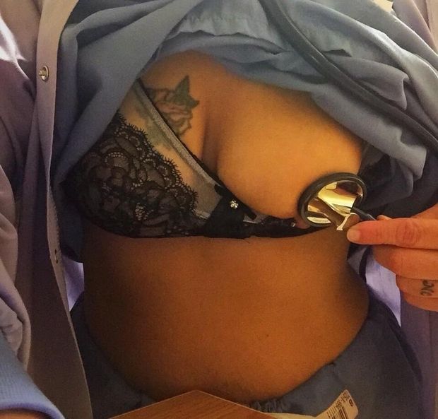Nurse Lifting Up Her Shirt Using A Stethoscope On Cufo510